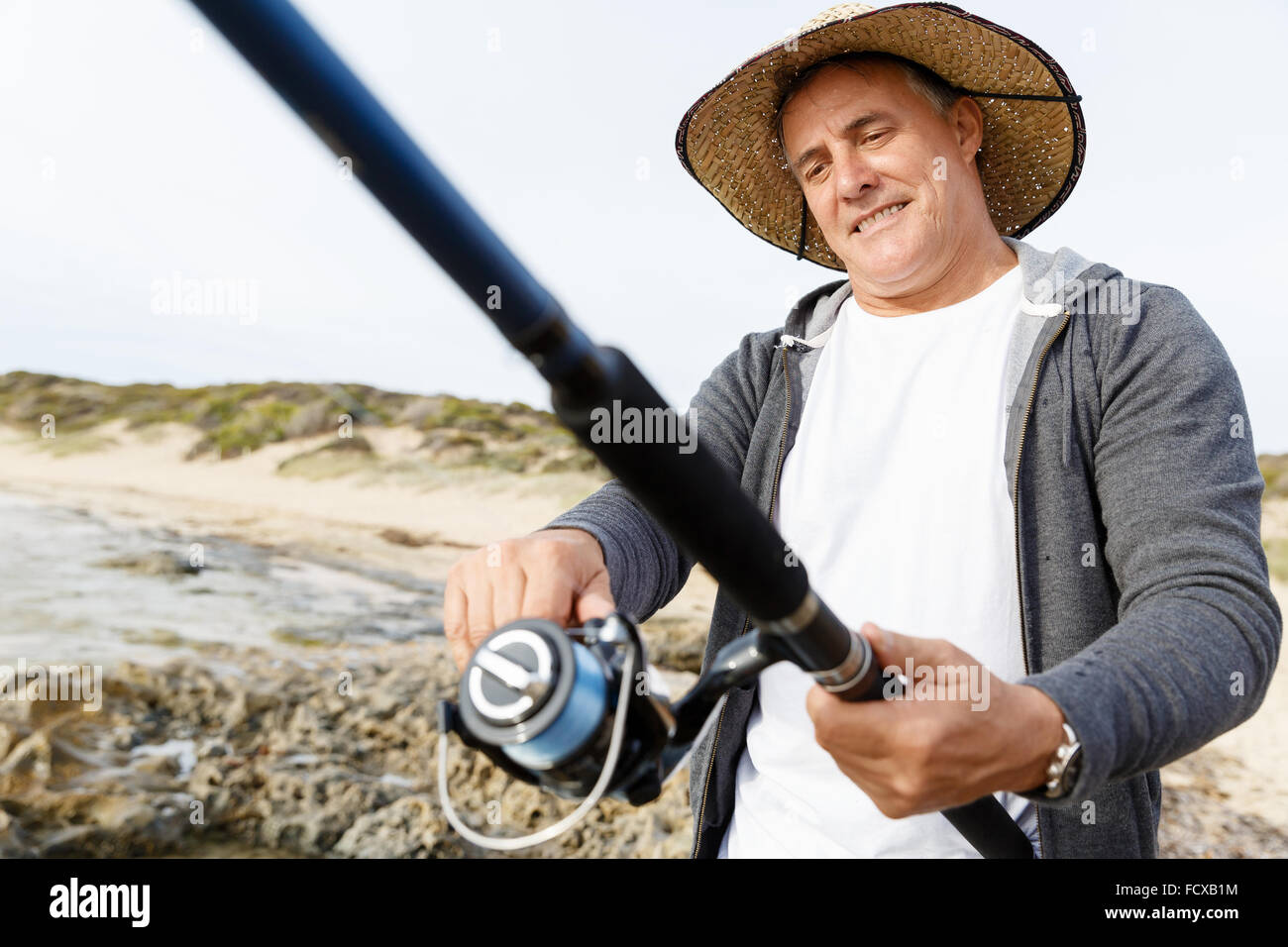 Picture of fisherman fishing with rods Stock Photo - Alamy