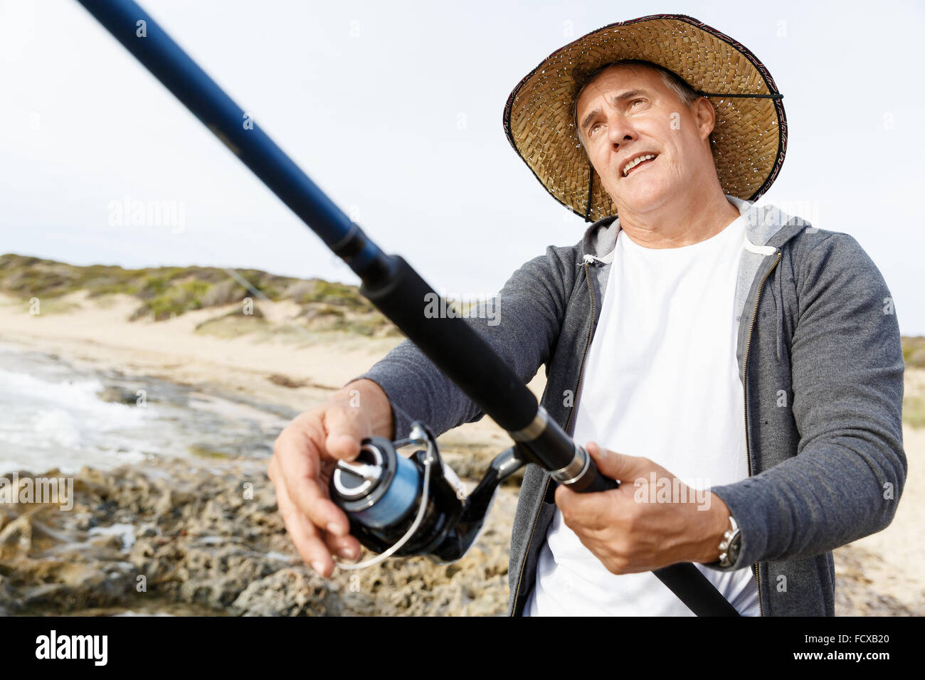 Picture of fisherman fishing with rods Stock Photo - Alamy