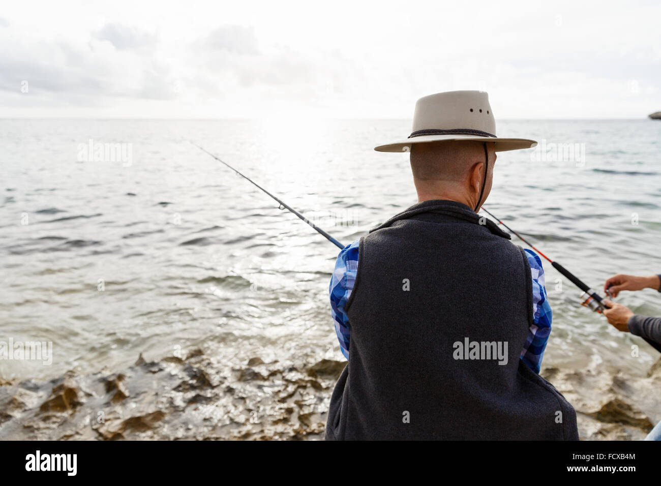 Picture of fisherman fishing with rods Stock Photo - Alamy