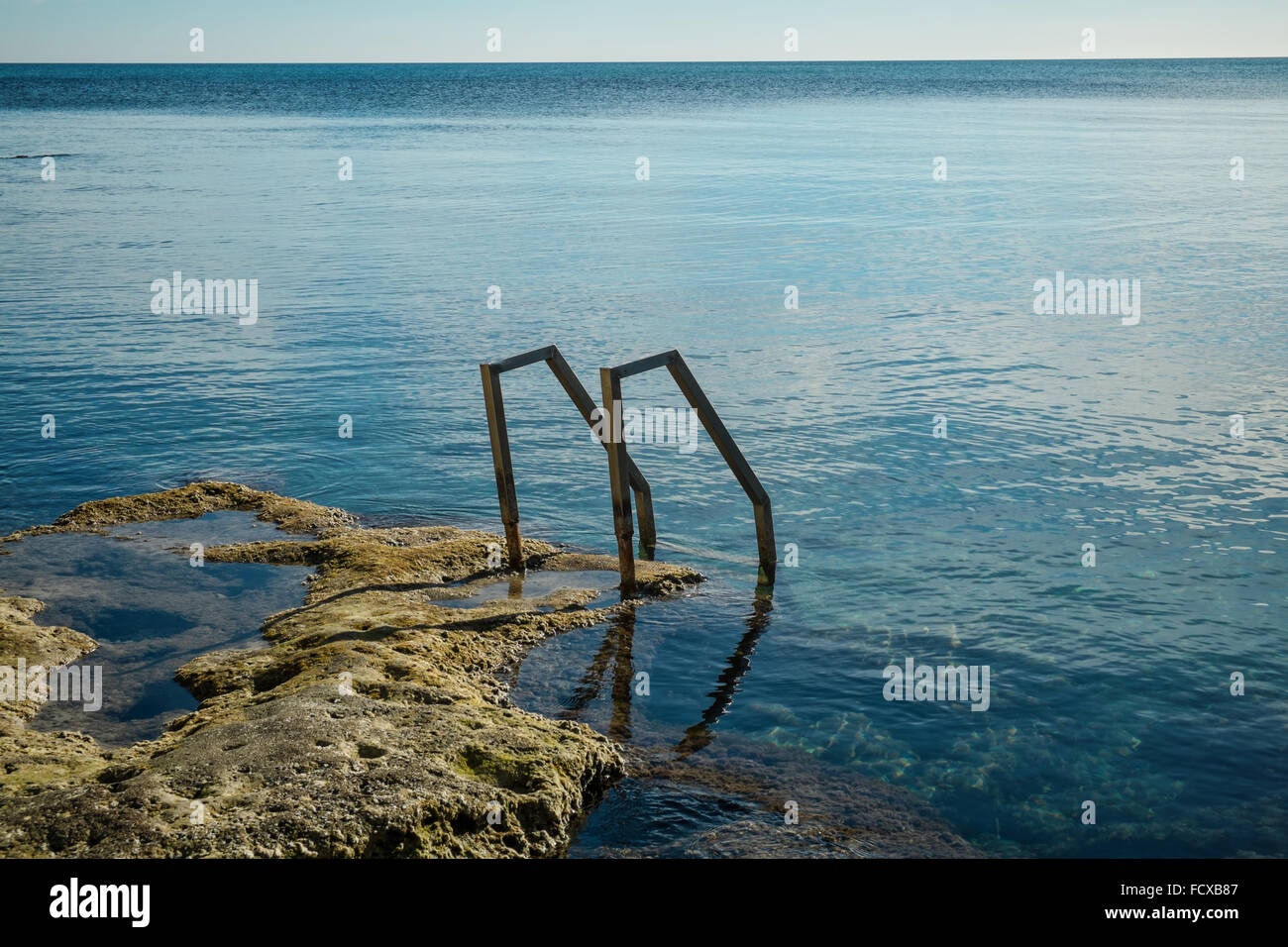 Ladder in a natural seawater pool on a Mediterranean beach resort Stock ...