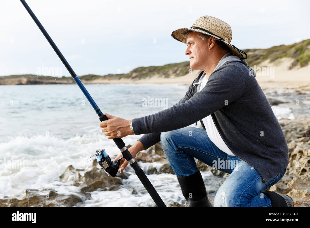 Picture of fisherman fishing with rods Stock Photo - Alamy