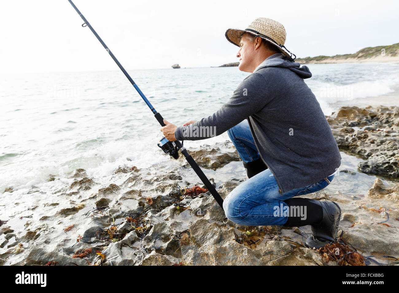 Picture of fisherman fishing with rods Stock Photo - Alamy