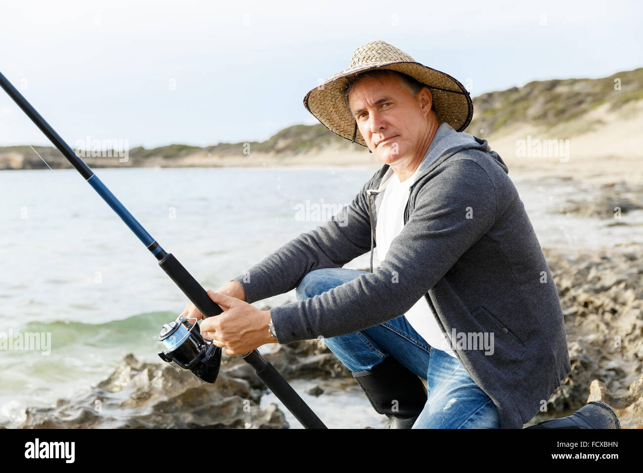 Picture of fisherman fishing with rods Stock Photo - Alamy