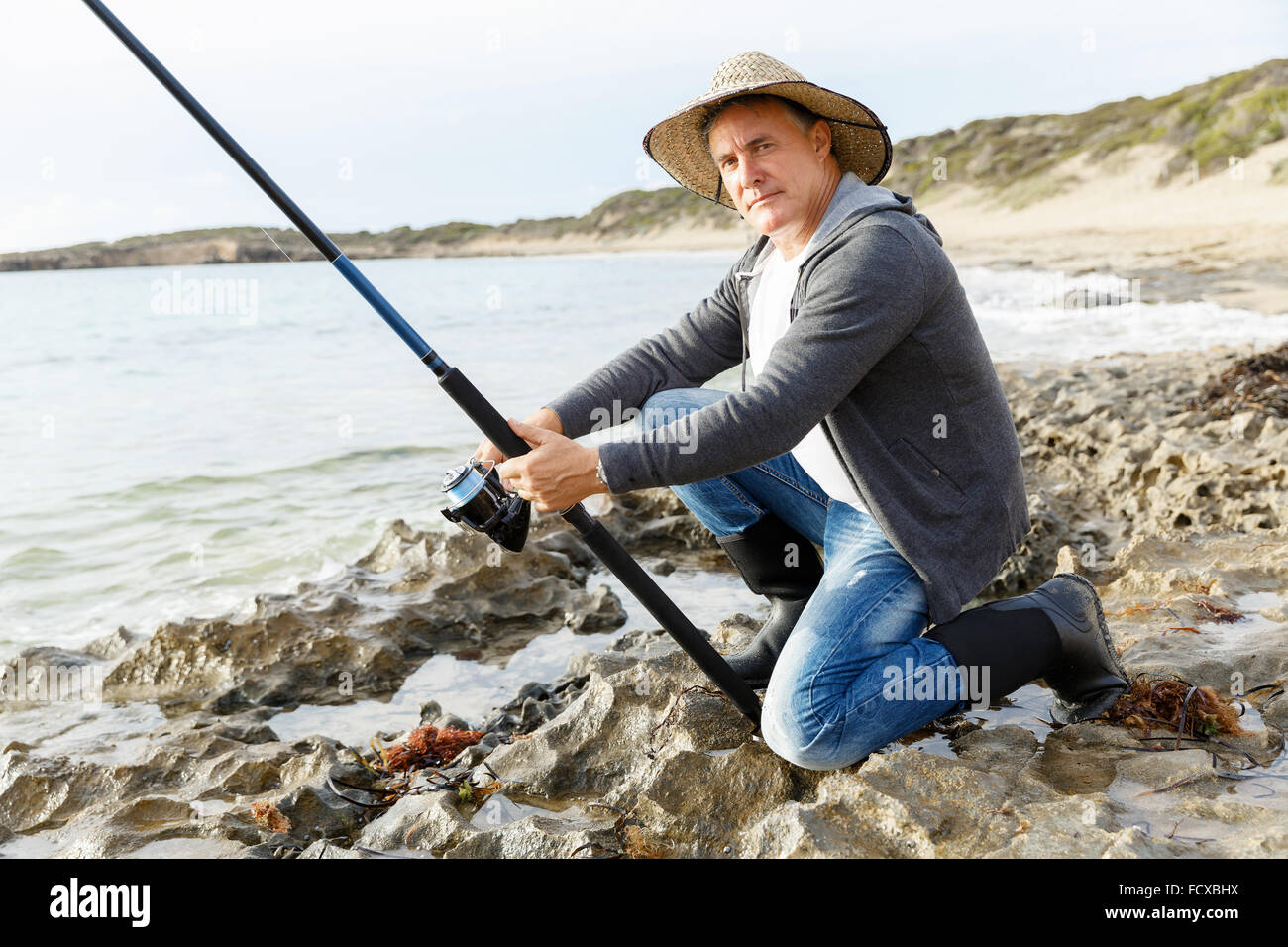 Picture of fisherman fishing with rods Stock Photo - Alamy