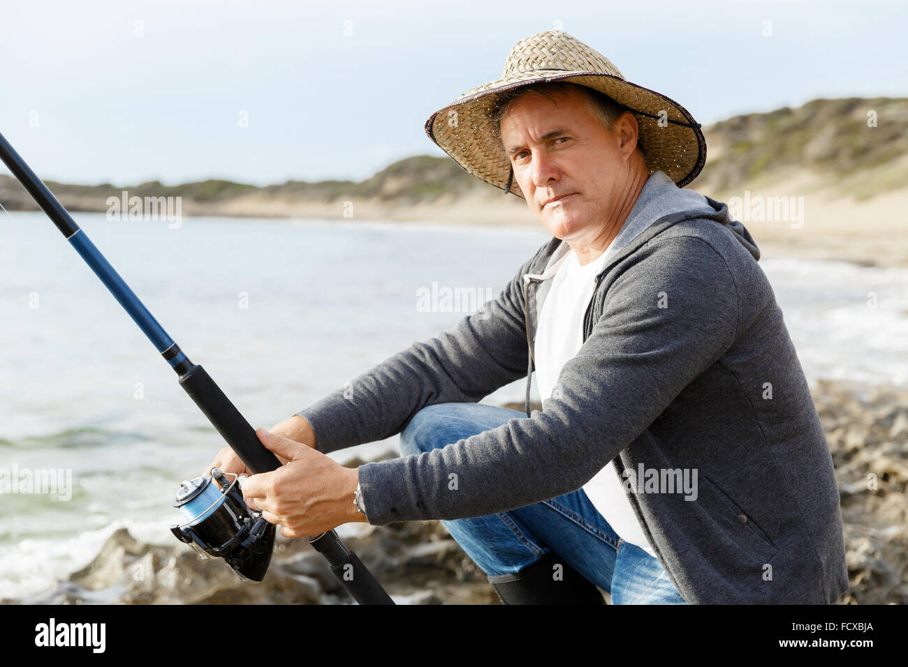 Picture of fisherman fishing with rods Stock Photo - Alamy