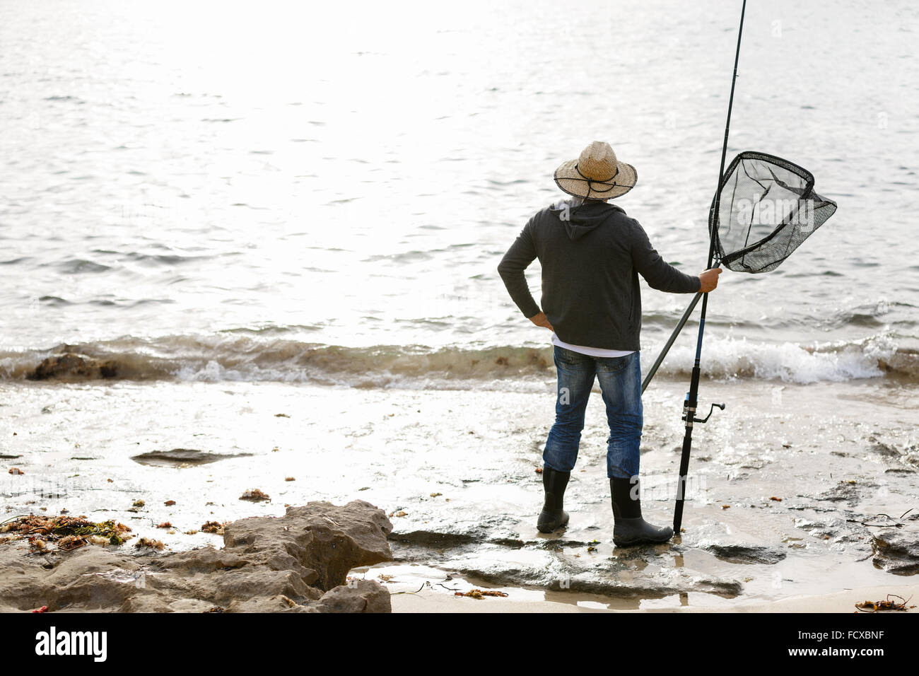 Picture of fisherman fishing with rods Stock Photo - Alamy