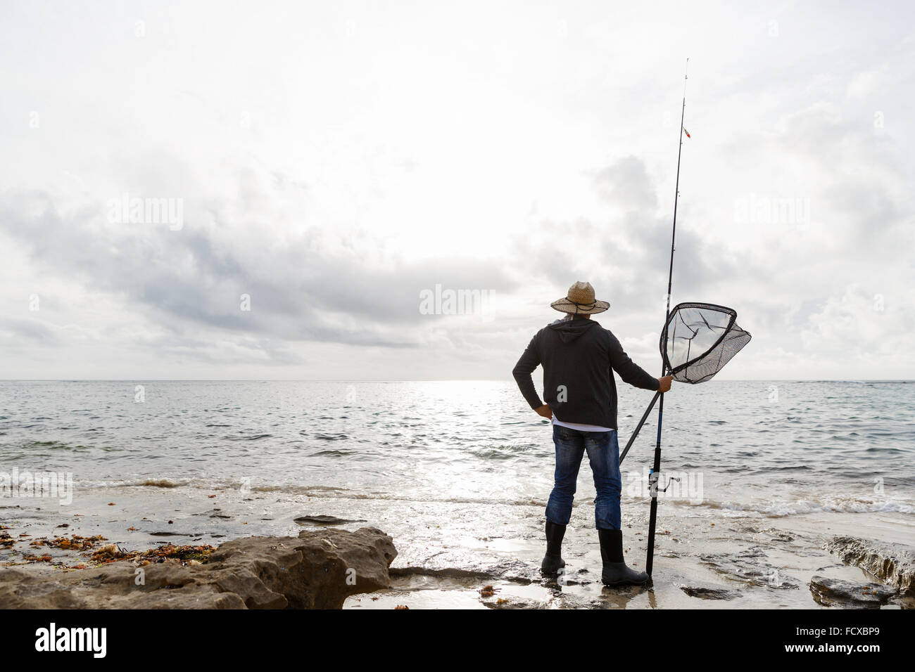 Picture of fisherman fishing with rods Stock Photo - Alamy