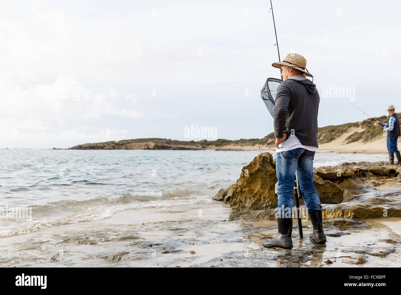 Picture of fisherman fishing with rods Stock Photo - Alamy