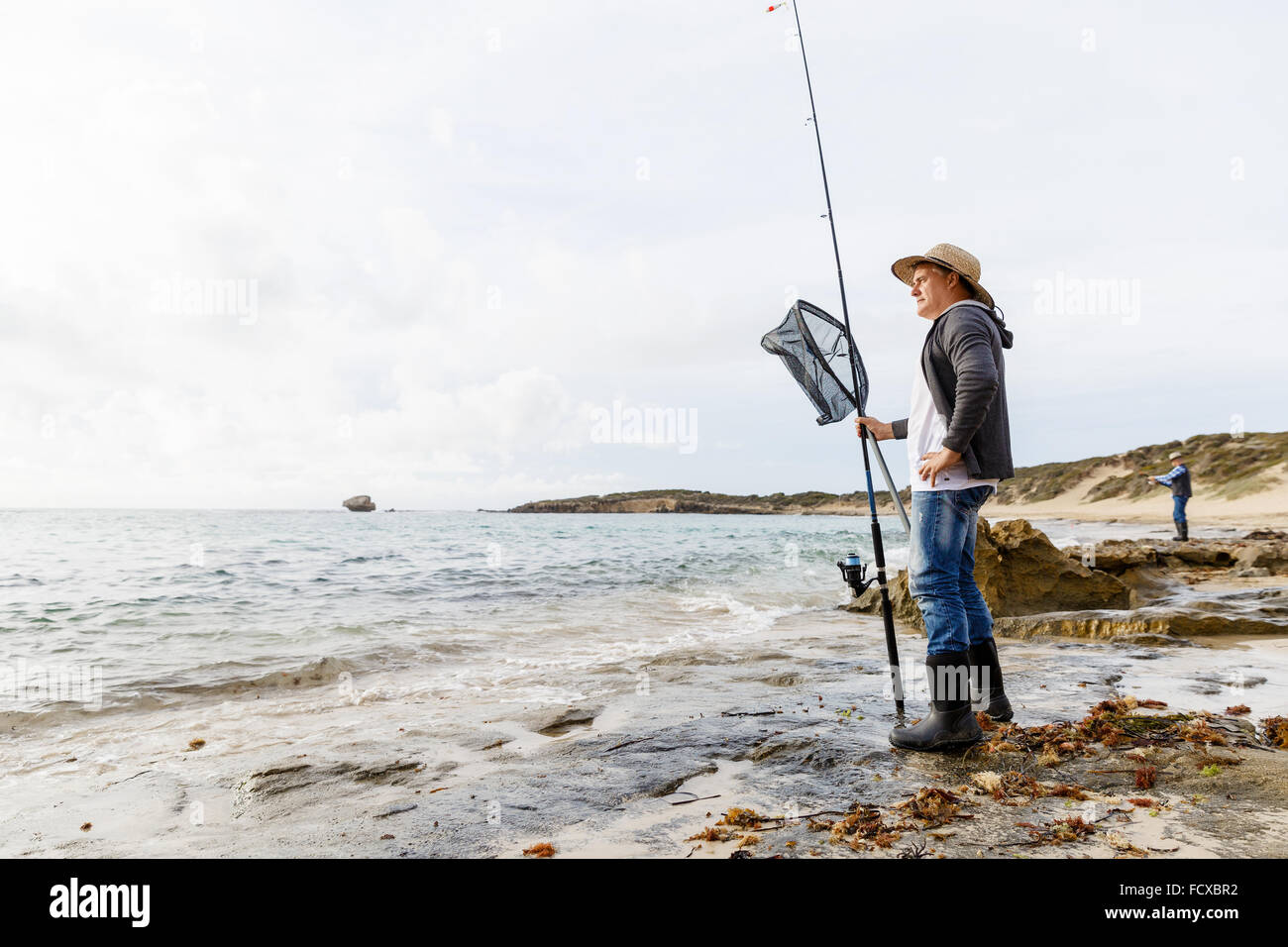 Picture of fisherman fishing with rods Stock Photo - Alamy