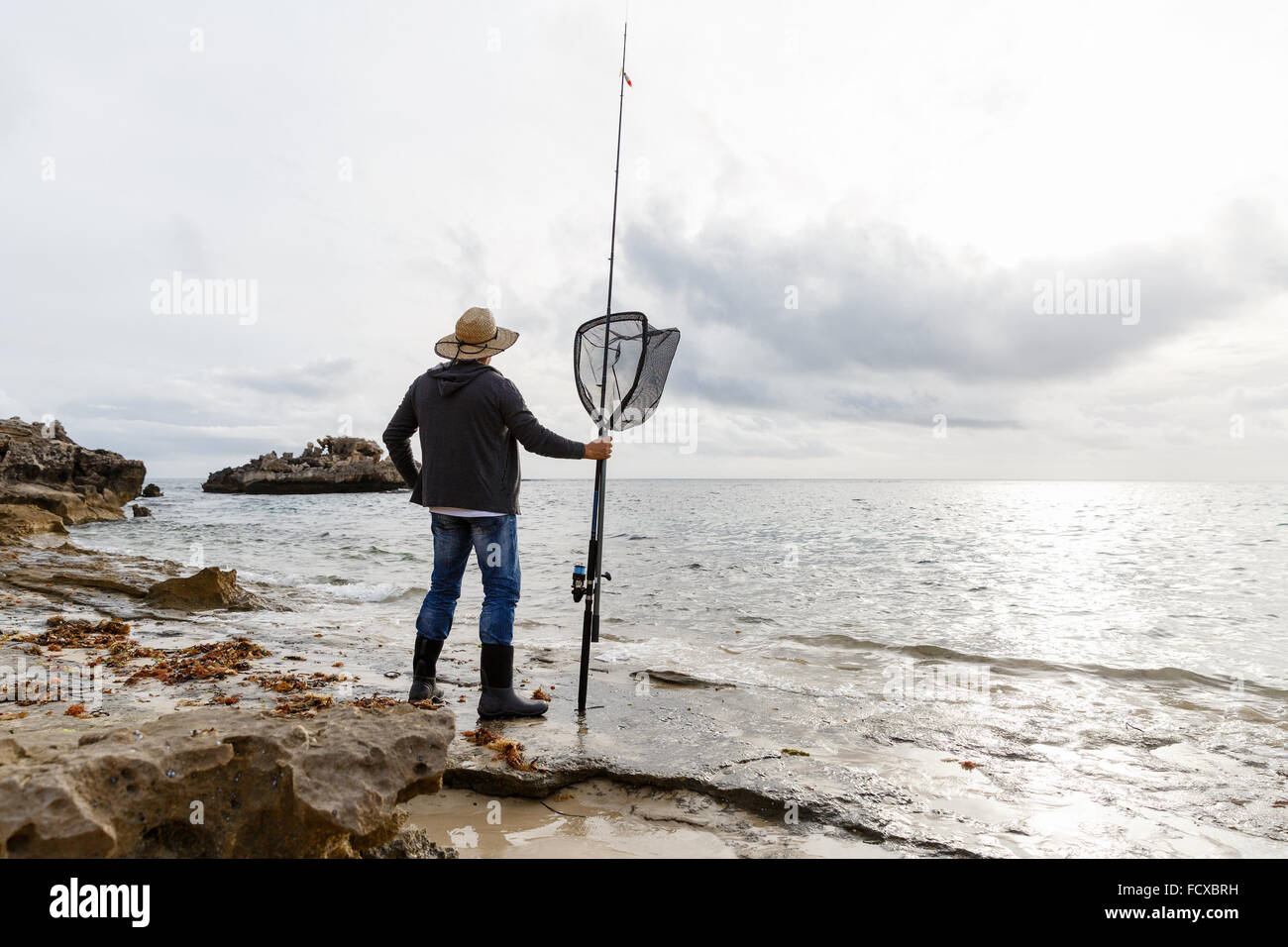 Picture of fisherman fishing with rods Stock Photo - Alamy