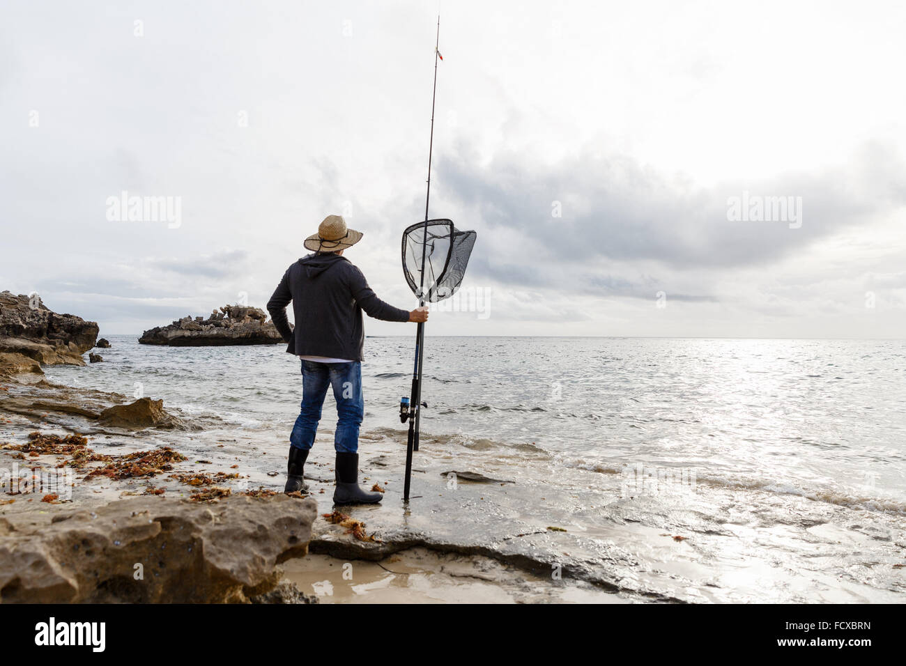 Picture of fisherman fishing with rods Stock Photo - Alamy