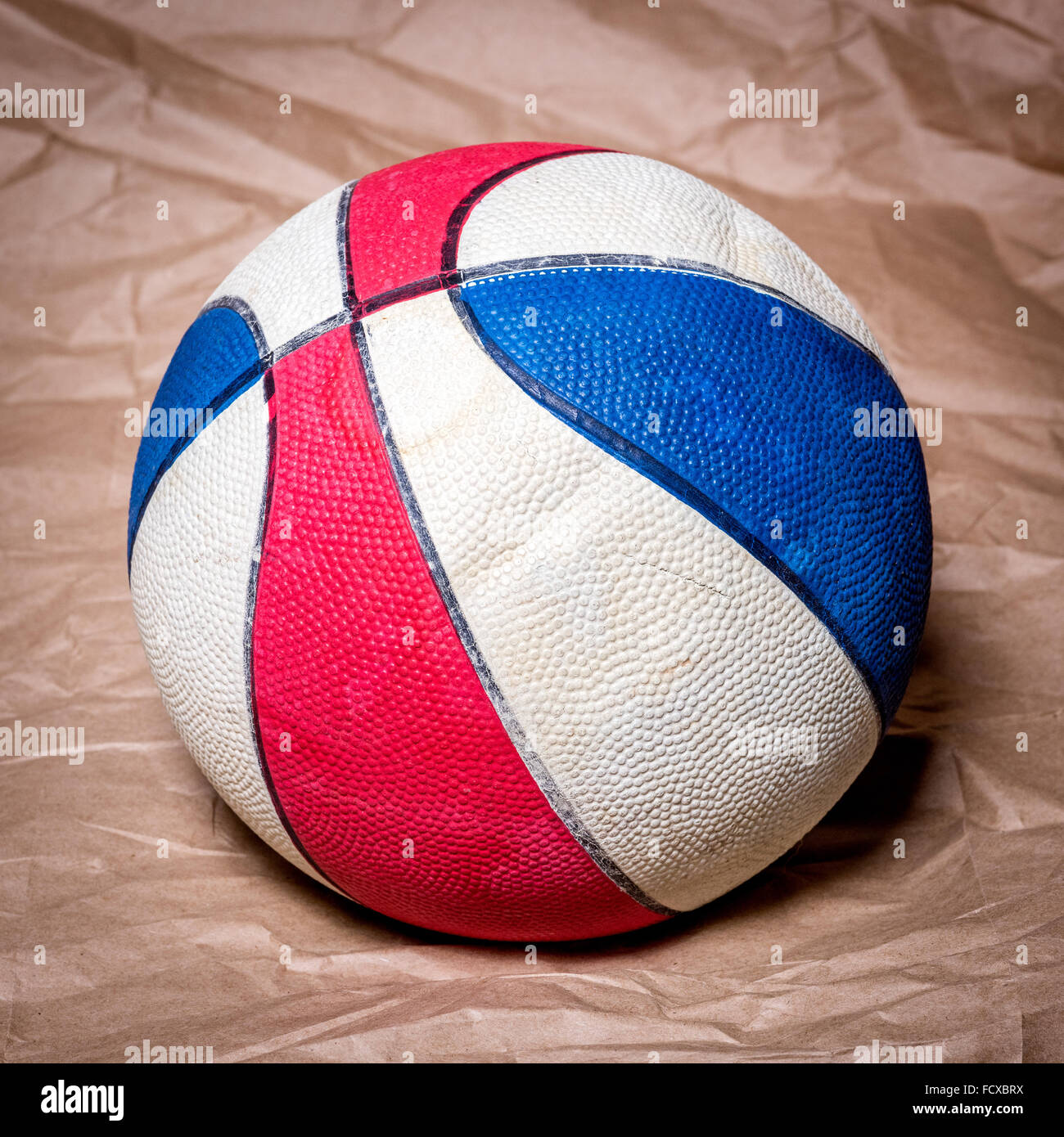 Partially de-inflated basketball that is red white and blue Stock Photo ...