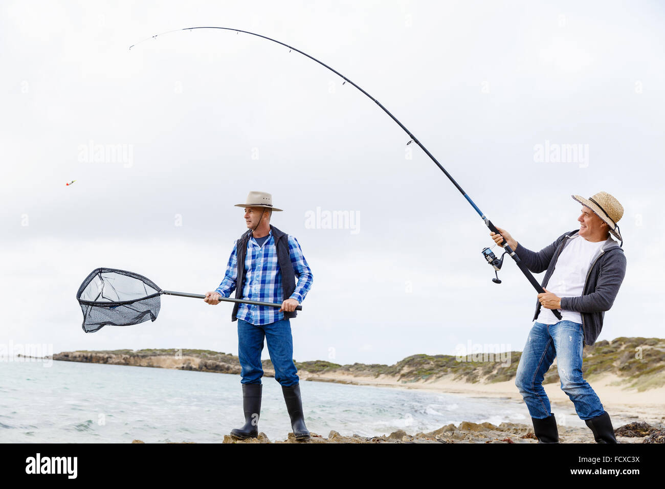 Picture of fishermen fishing with rods Stock Photo - Alamy