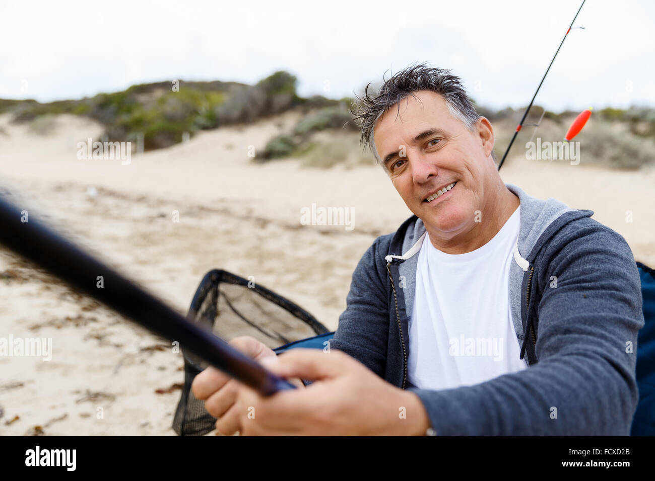 Picture of fisherman fishing with rods Stock Photo - Alamy