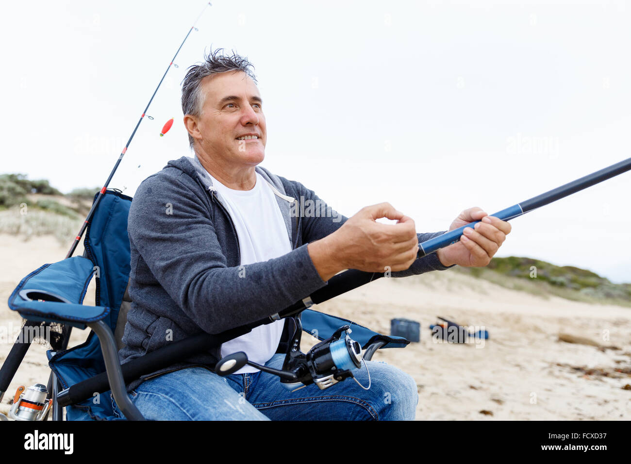 Picture of fisherman fishing with rods Stock Photo - Alamy