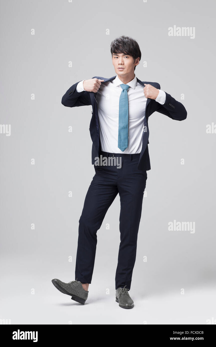 Man in business outfits putting on his jacket and staring forward Stock ...