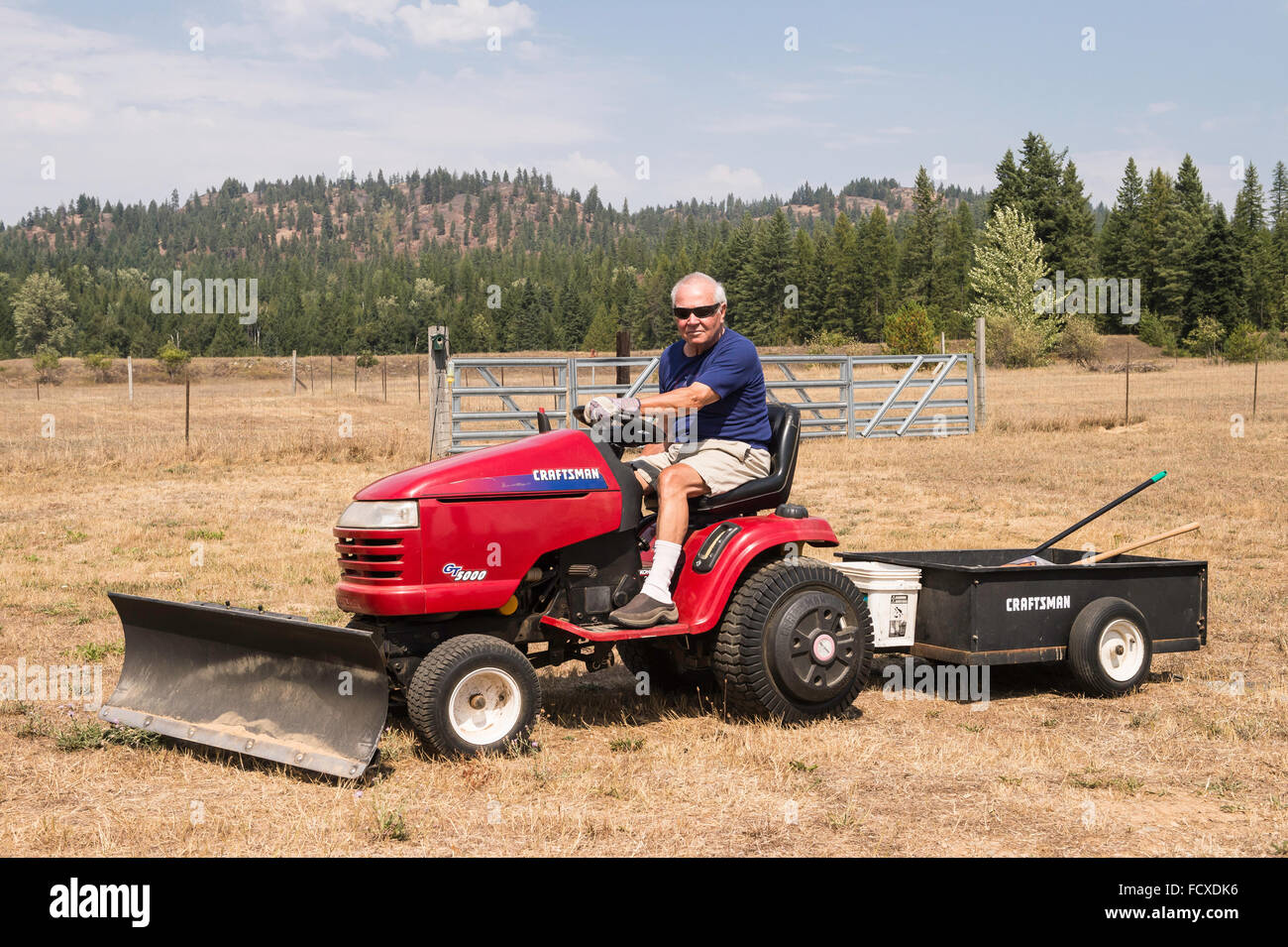 Man sitting on tractor hi-res stock photography and images - Alamy