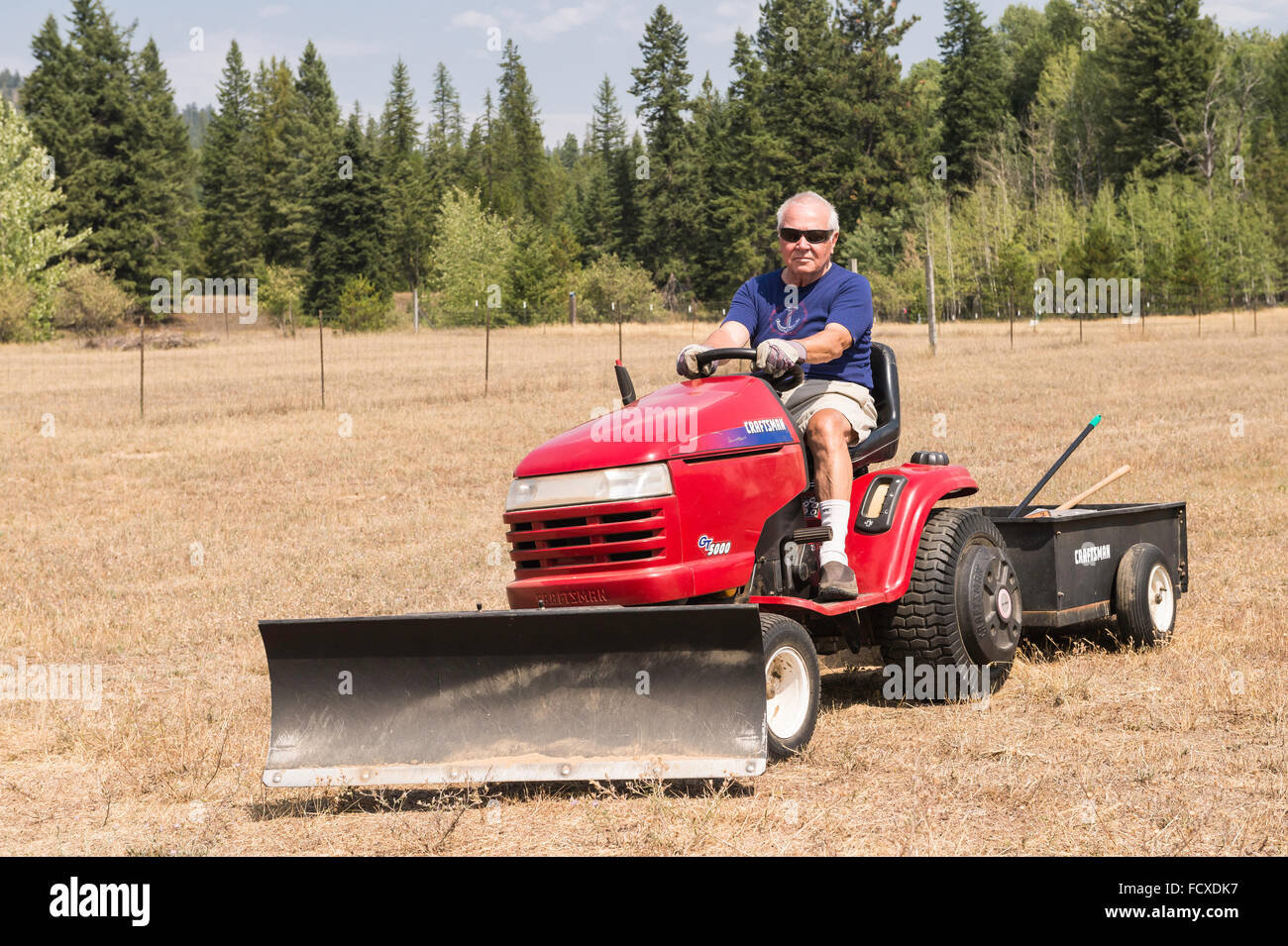 Man sitting on tractor hi-res stock photography and images - Alamy