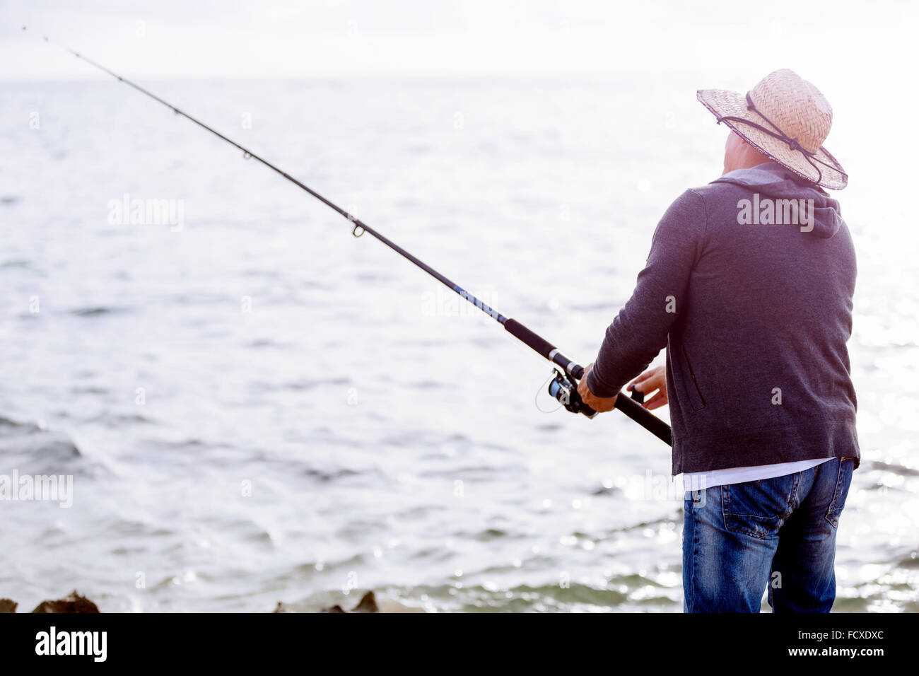 Picture of fisherman fishing with rods Stock Photo - Alamy