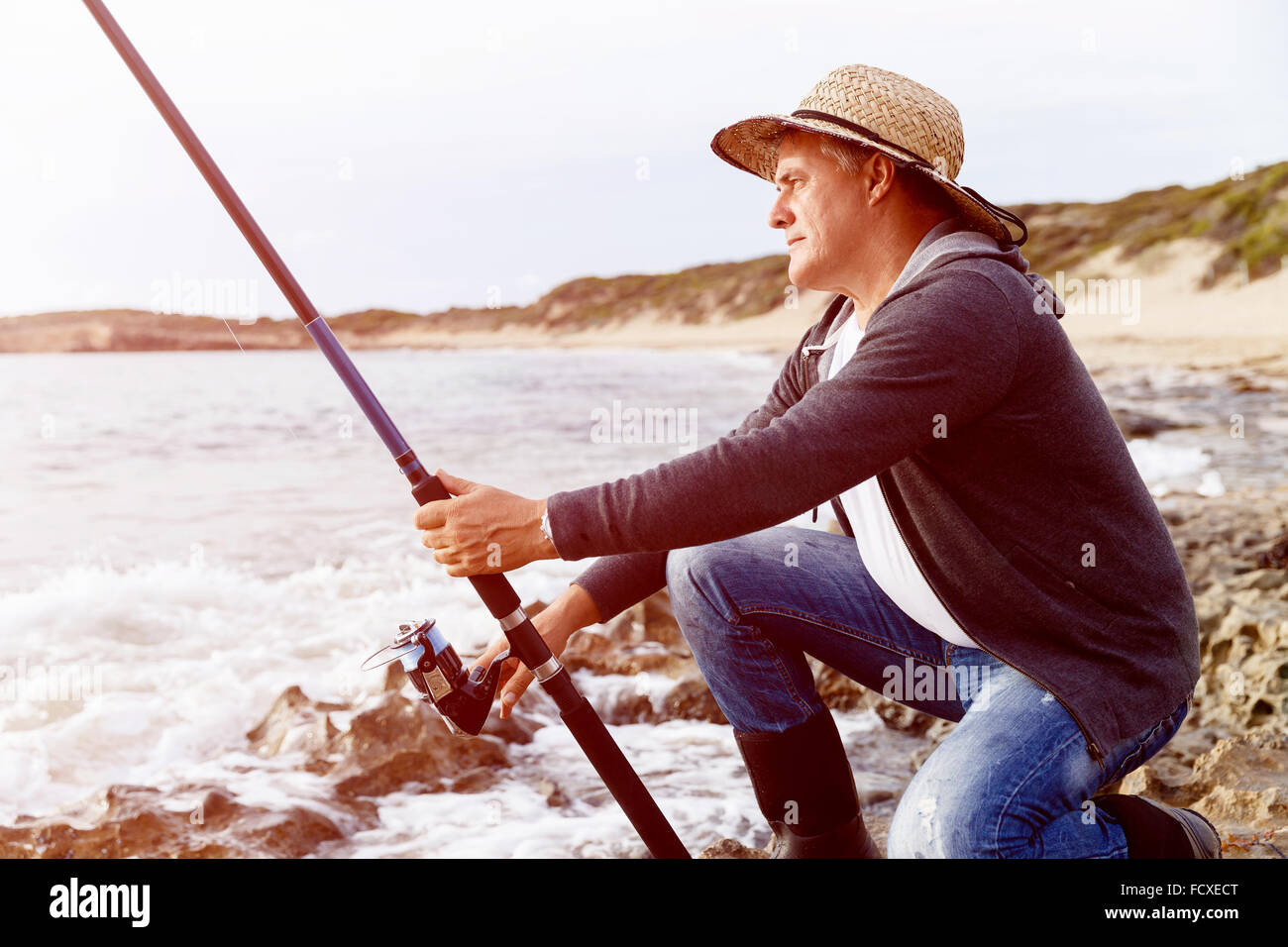 Picture of fisherman fishing with rods Stock Photo - Alamy