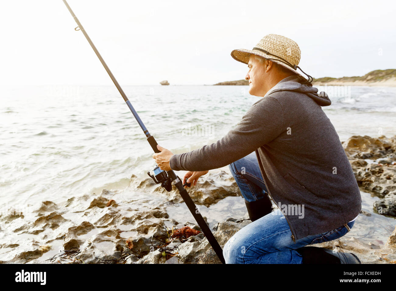 Picture of fisherman fishing with rods Stock Photo - Alamy