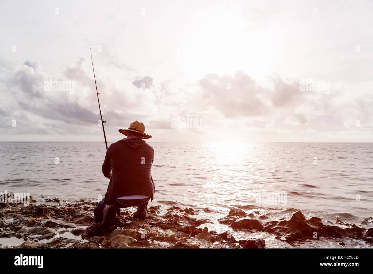 Picture of fisherman fishing with rods Stock Photo - Alamy