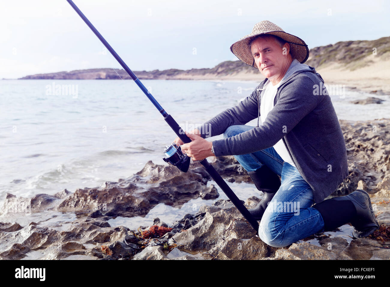 Picture of fisherman fishing with rods Stock Photo - Alamy