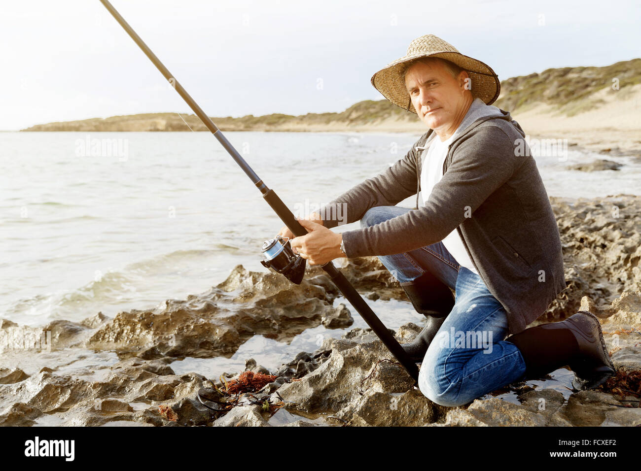 Picture of fisherman fishing with rods Stock Photo - Alamy