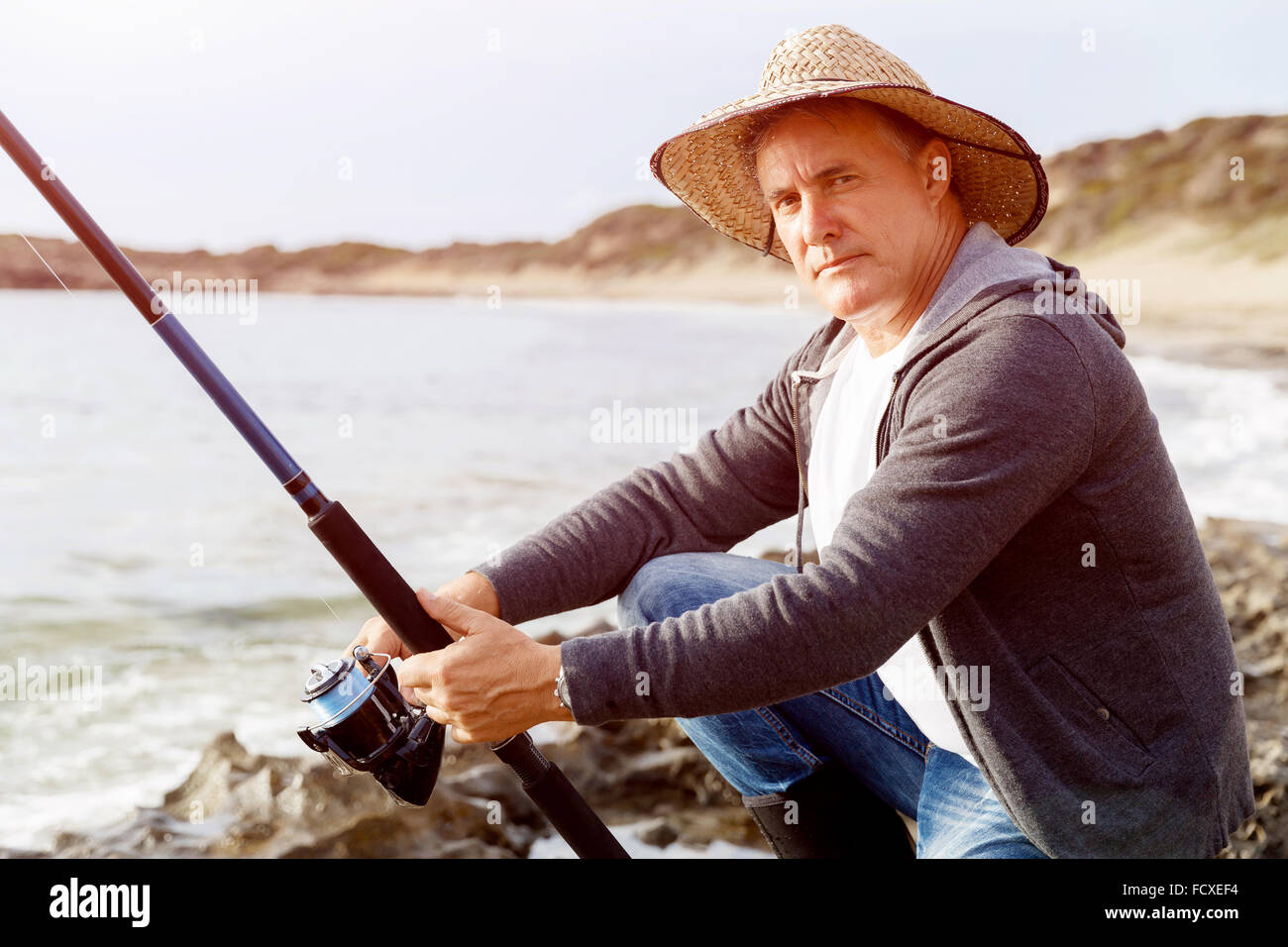 Picture of fisherman fishing with rods Stock Photo - Alamy