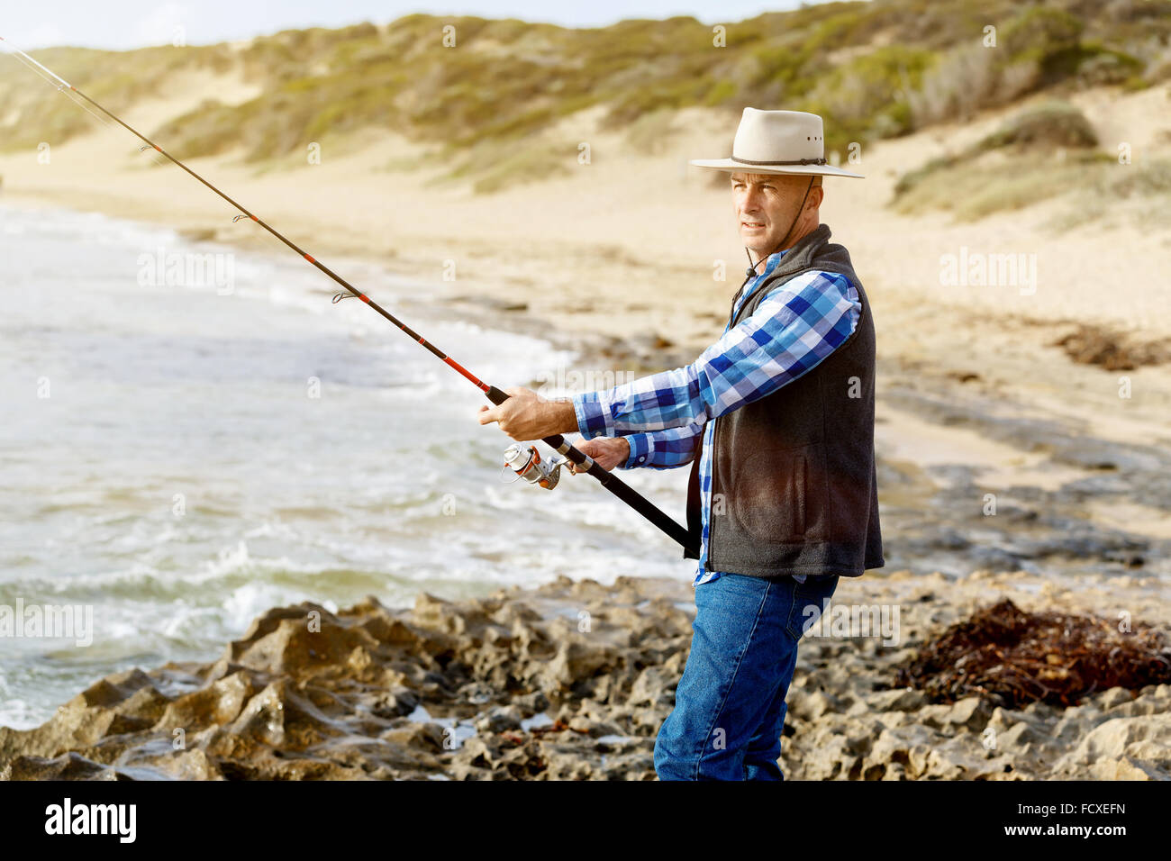 Picture of fisherman fishing with rods Stock Photo - Alamy