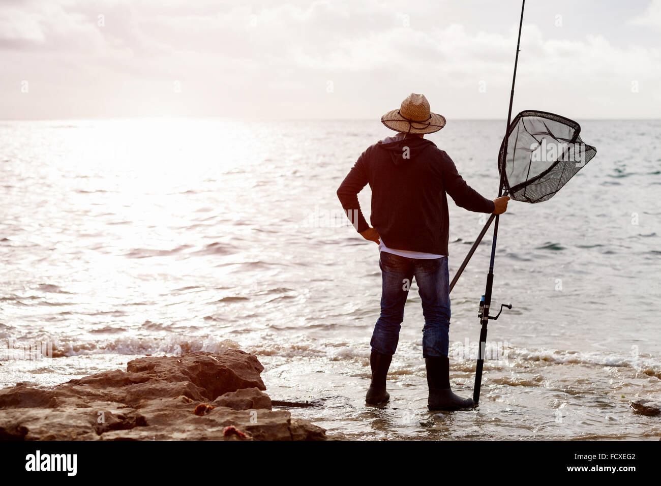 Picture of fisherman fishing with rods Stock Photo - Alamy