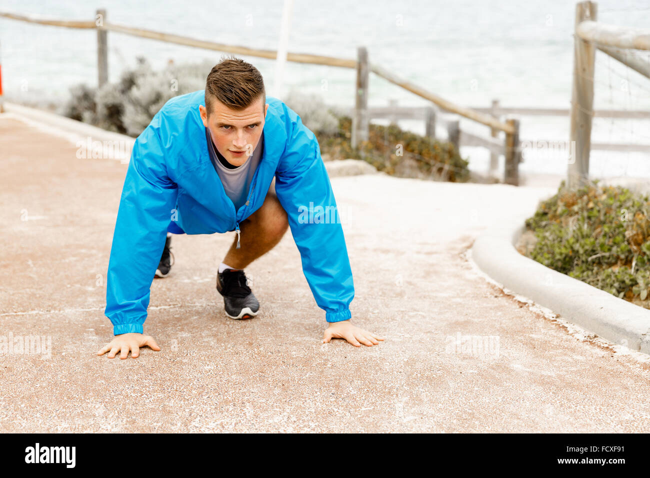 Male runner getting ready to start his race Stock Photo - Alamy