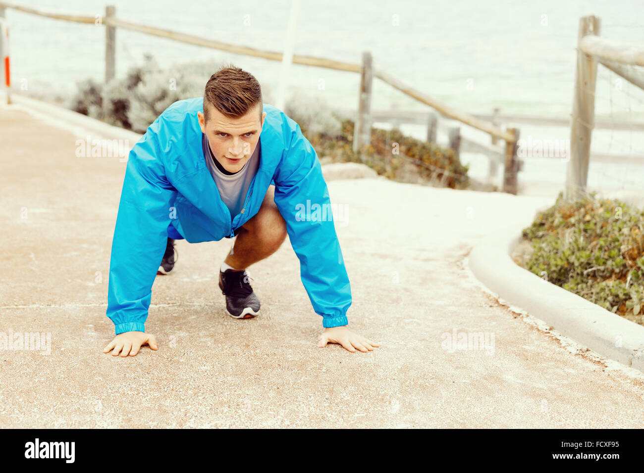 Male runner getting ready to start his race Stock Photo - Alamy