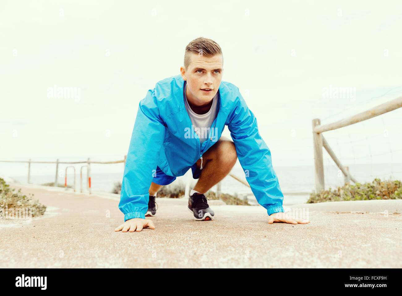 Male runner getting ready to start his race Stock Photo - Alamy