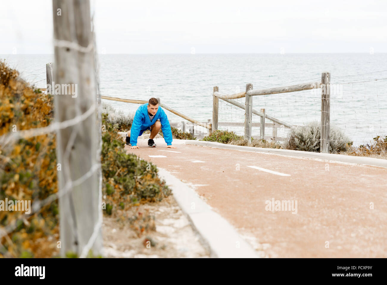 Male runner getting ready to start his race Stock Photo - Alamy