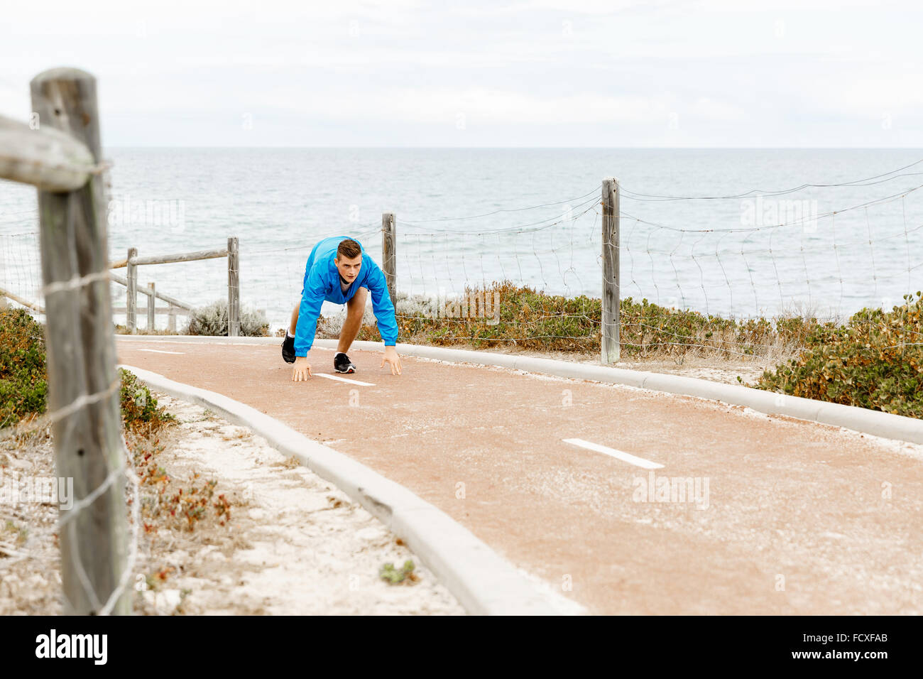 Male runner getting ready to start his race Stock Photo - Alamy