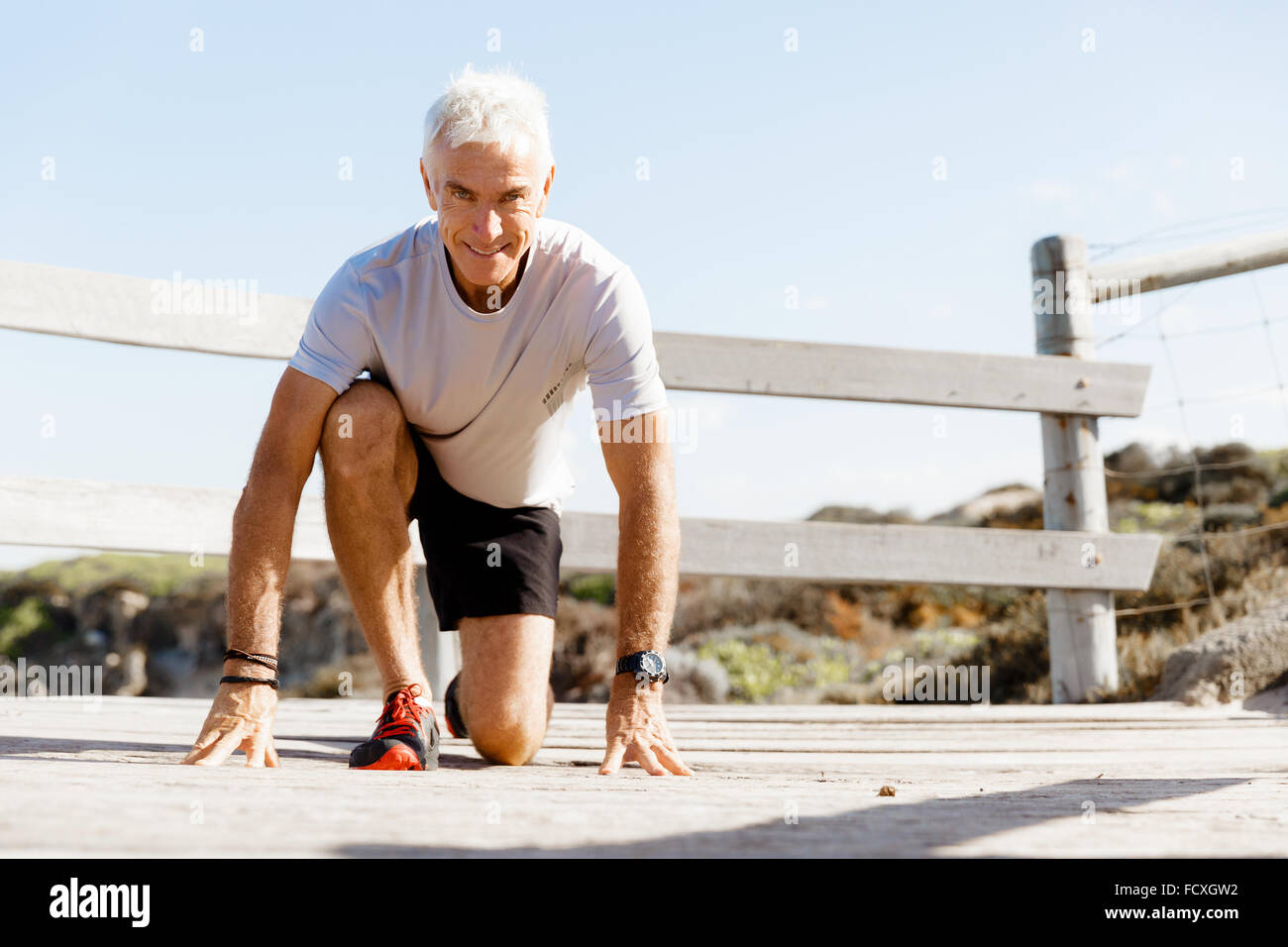 Male runner getting ready to start his race Stock Photo - Alamy