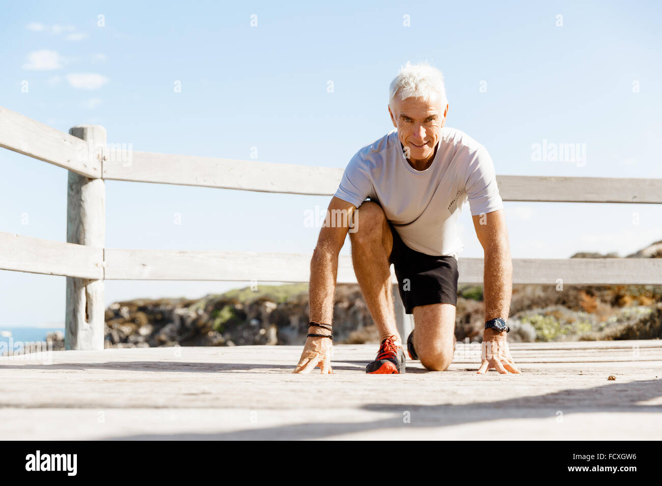 Male runner getting ready to start his race Stock Photo - Alamy