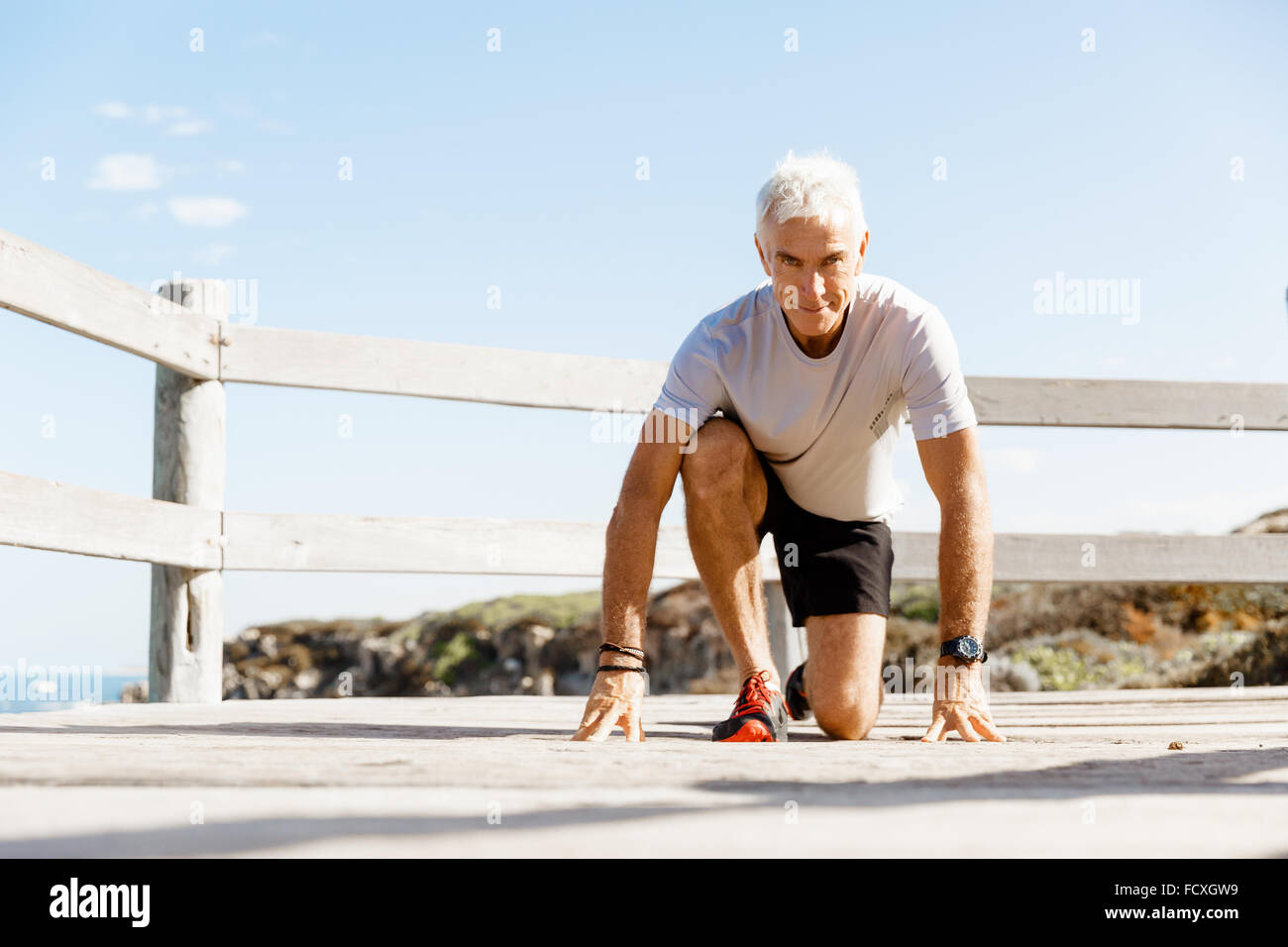 Male runner getting ready to start his race Stock Photo - Alamy