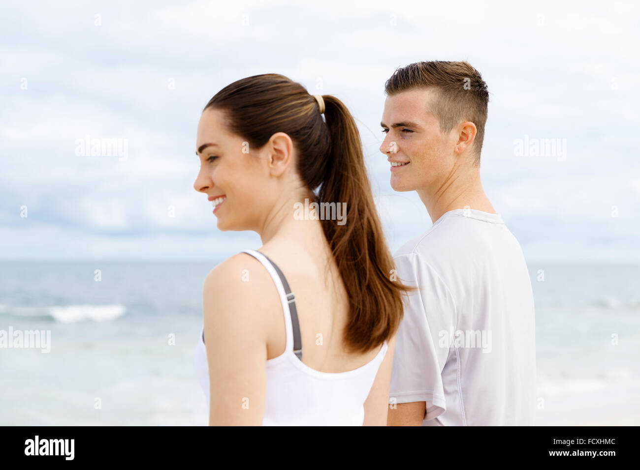 Young couple looking thoughtful while standing next to each other on ...