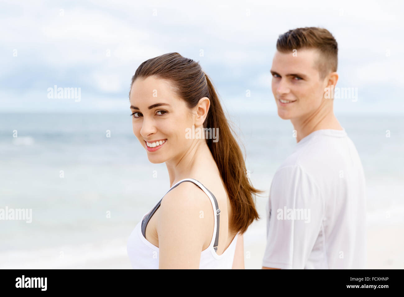 Young couple looking thoughtful while standing next to each other on ...