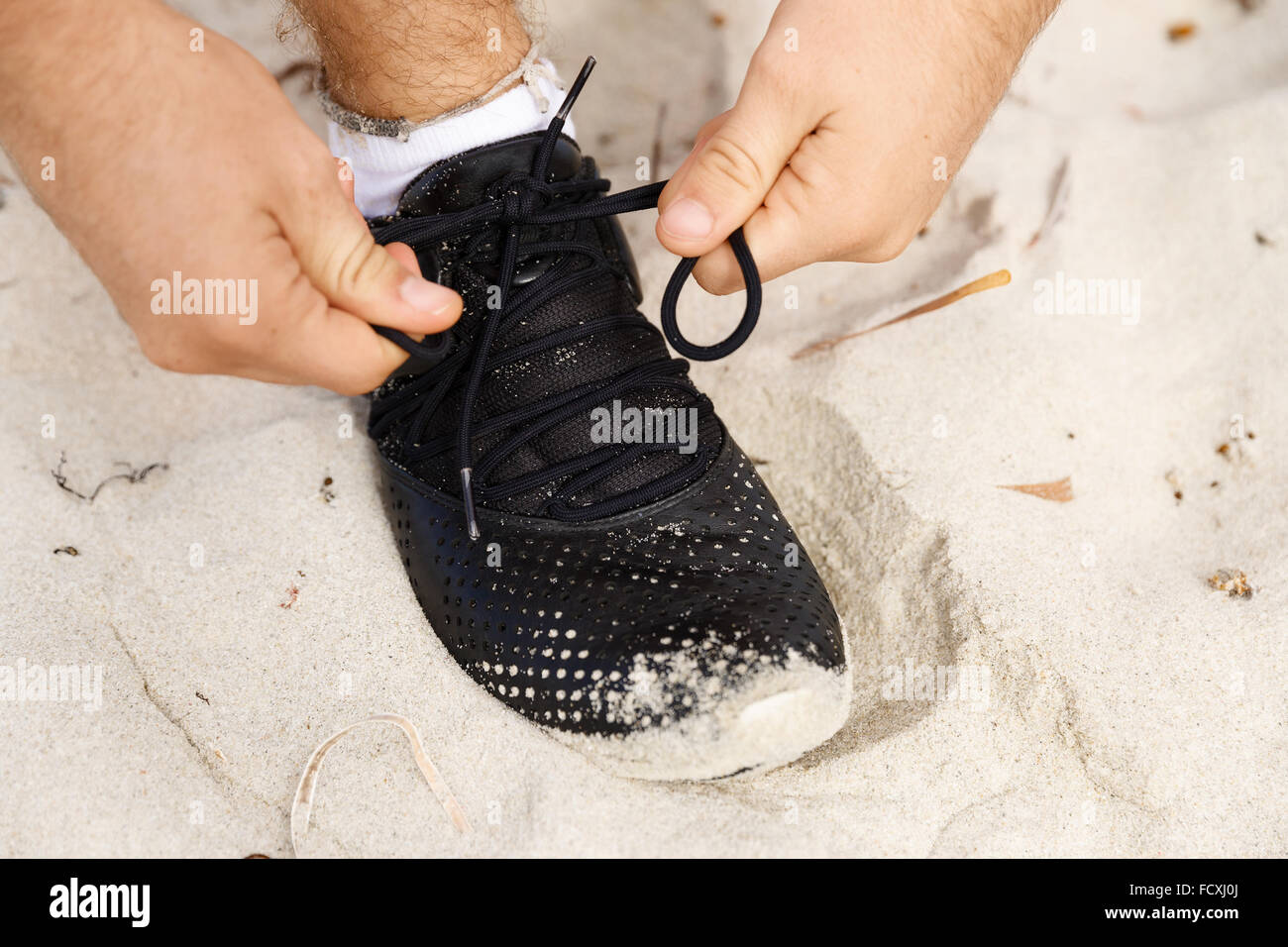 Male runner laces his shoes and prepares to jogging Stock Photo - Alamy