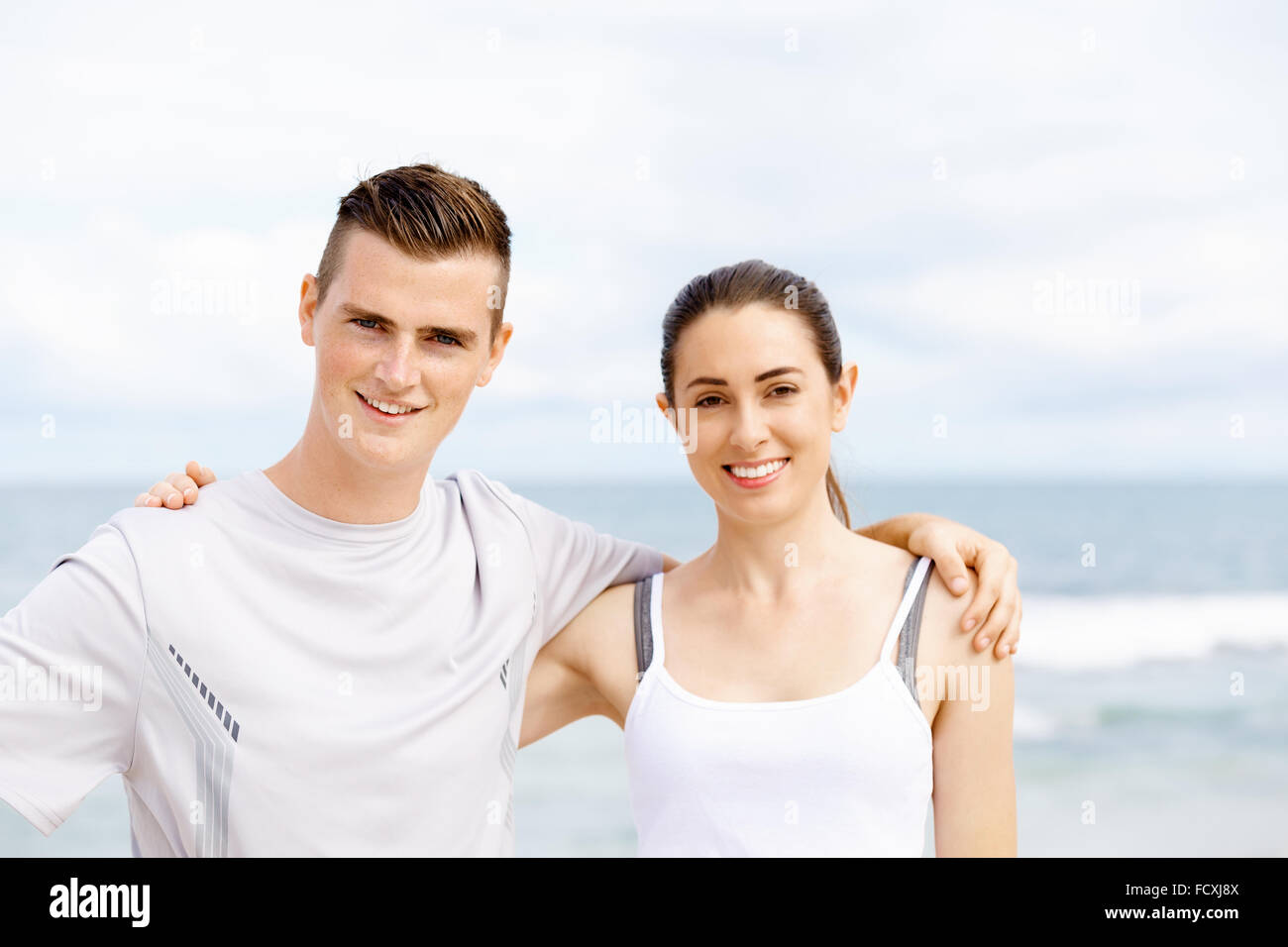 Young Couple Looking At Camera While Standing Next To Each Other On