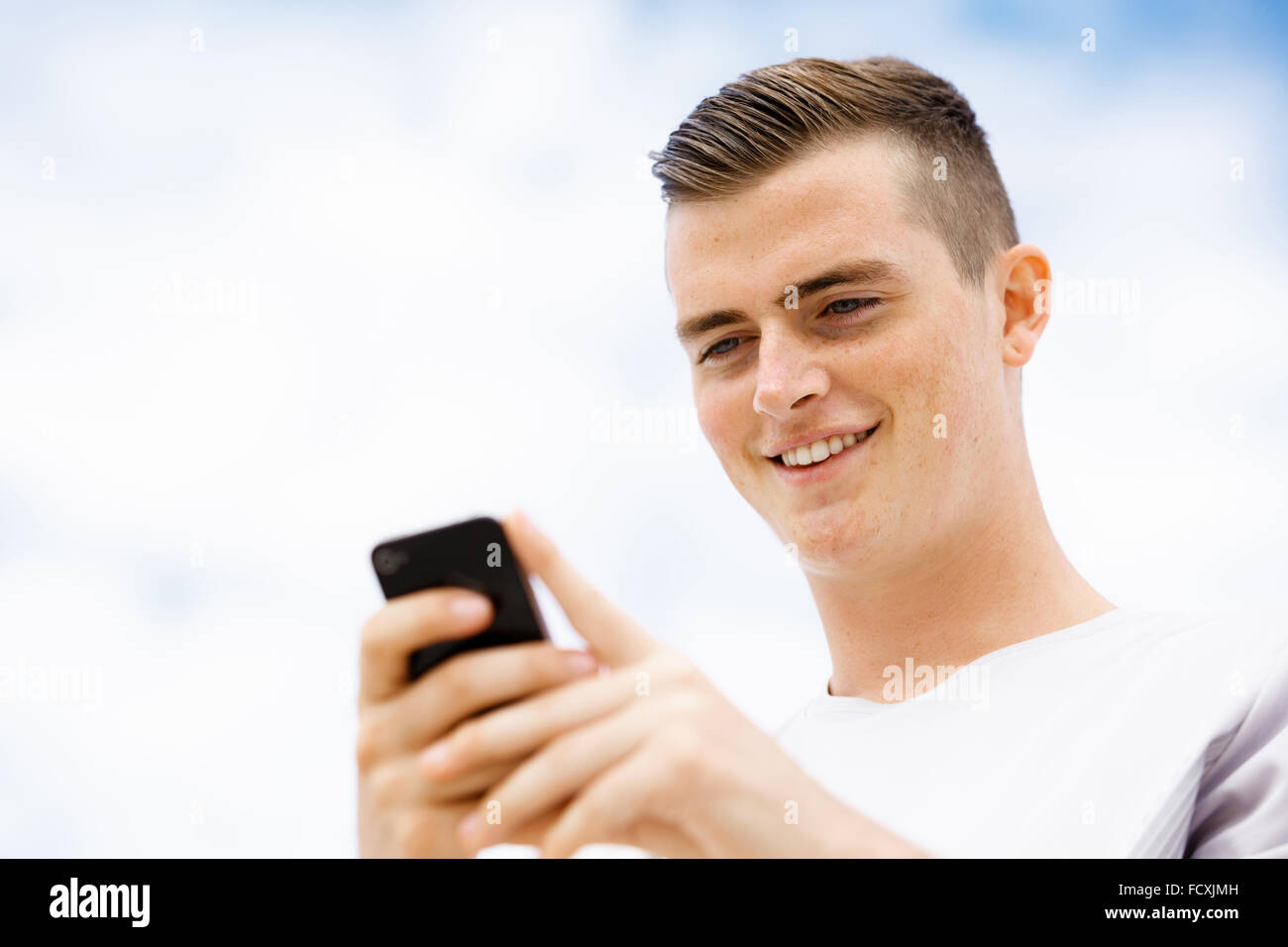 Young male runner with his mobile smart phone standing outdoors Stock ...