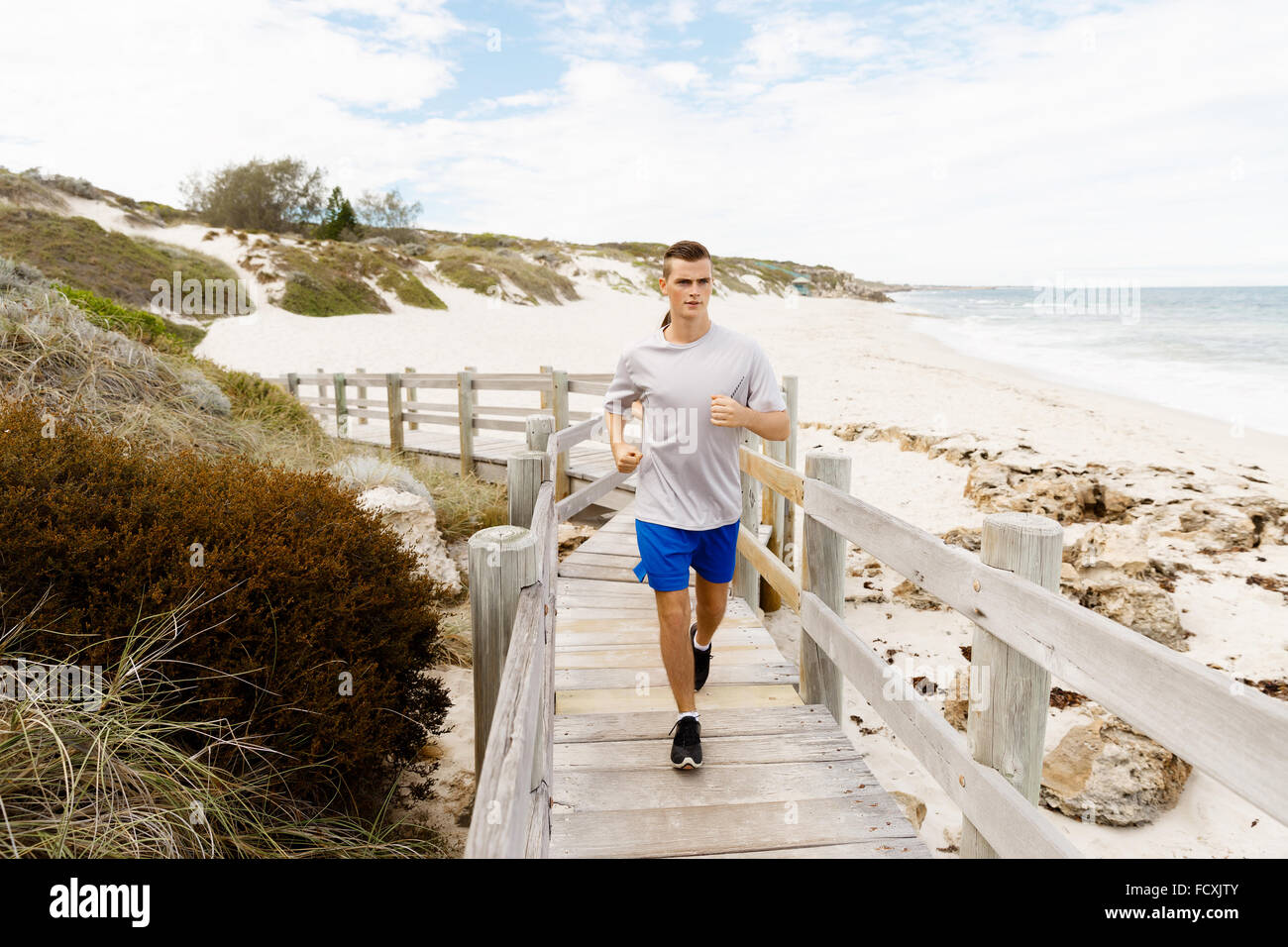 Caucasian couple jogging on beach hi-res stock photography and images ...
