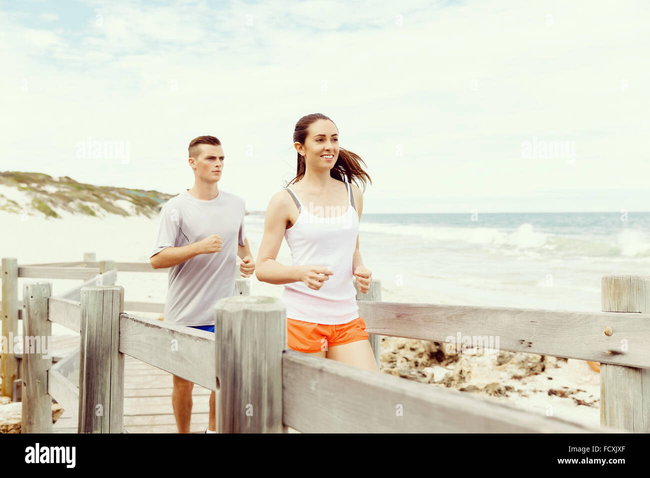 Caucasian couple jogging on beach hi-res stock photography and images ...