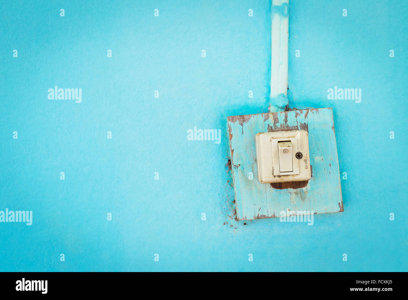 One old light switch on a blue background Stock Photo - Alamy