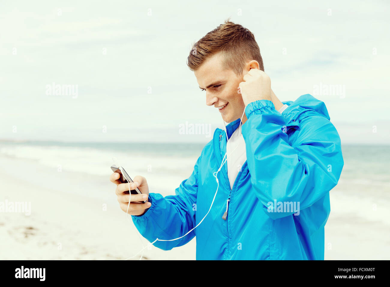 Sports and music. man getting ready for jogging and listening to the ...