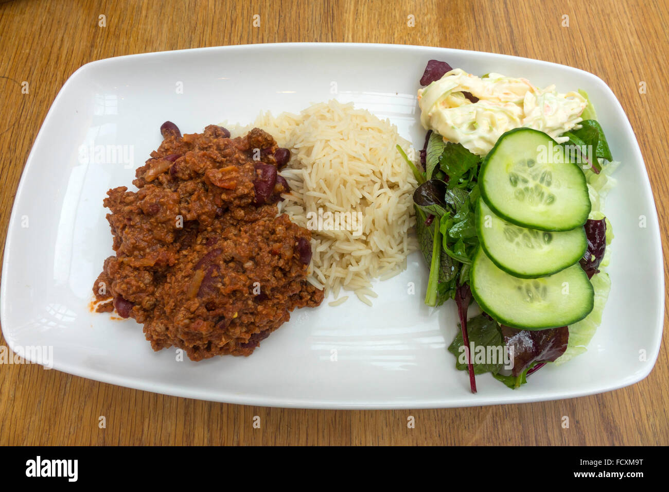 Lunch food Chilli con carne served with rice green salad and coleslaw ...