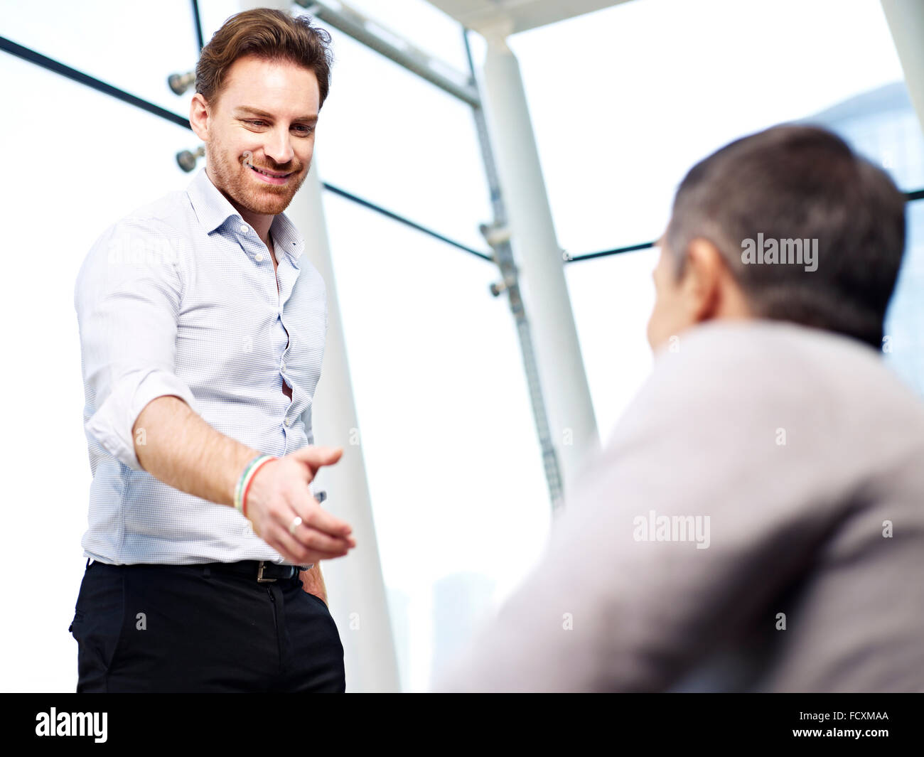 business executive reaching out for a handshake Stock Photo - Alamy